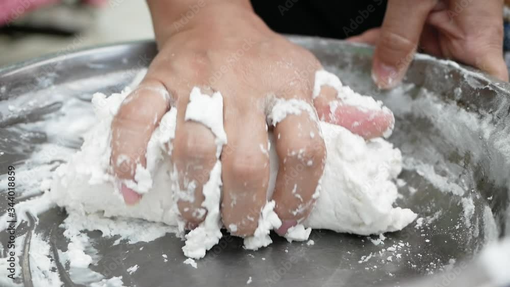 Asian young woman is making Thai dumplings dessert or Bualoy sweets ...