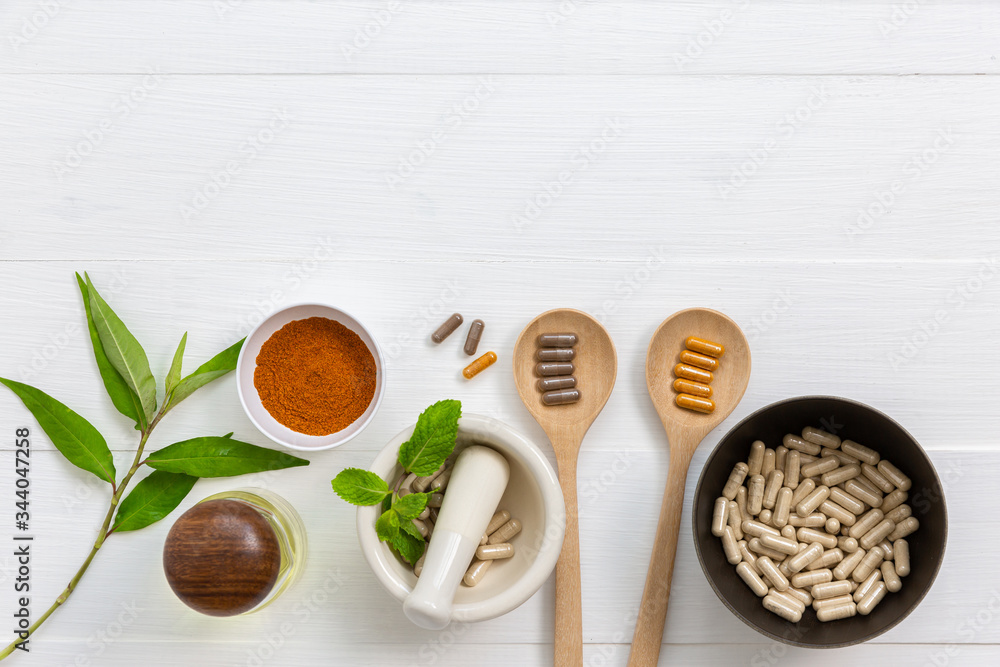 Herbal supplement in capsules with healthy medicinal plant.Alternative ...
