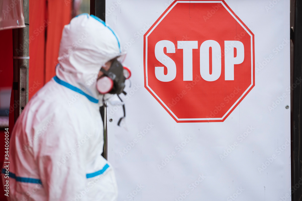 Employee of the medical laboratory and inscription "STOP" at the point ...