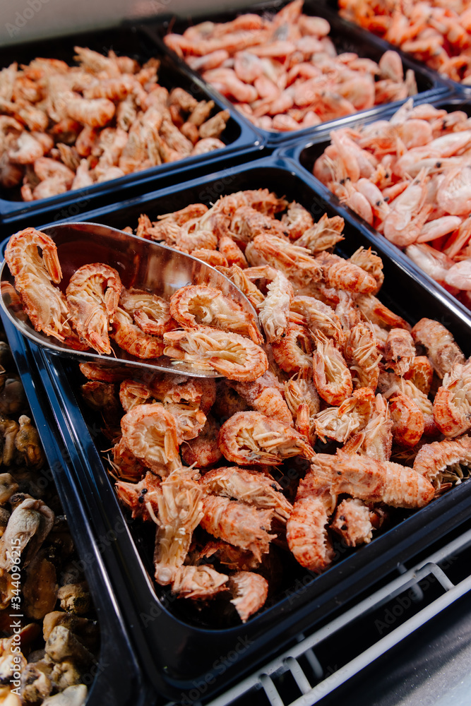 Frozen prawns in a supermarket refrigerated display case. Frozen ...