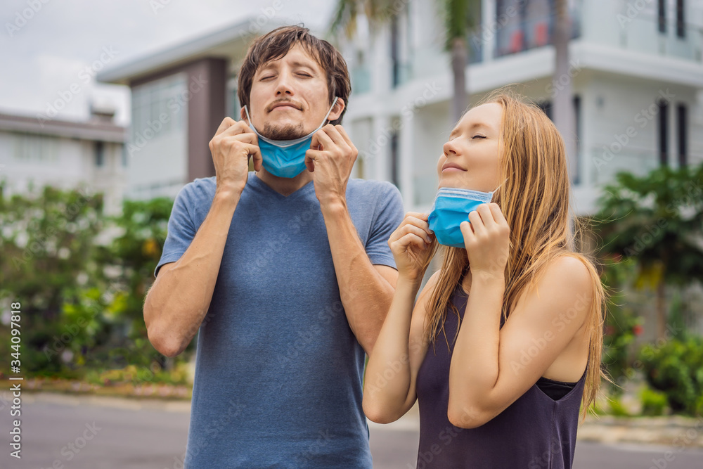Quarantine is over concept. Man and woman taking off mask against the ...