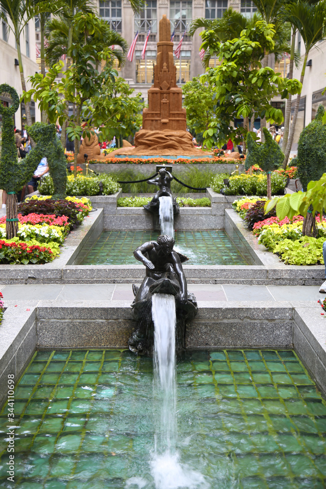 Rockefeller Plaza, Beautiful blooming flower, fountain and sculpture in ...