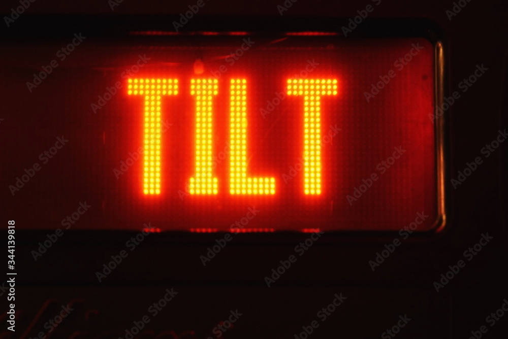Illuminated Tilt Orange Text In Darkroom Stock Photo | Adobe Stock