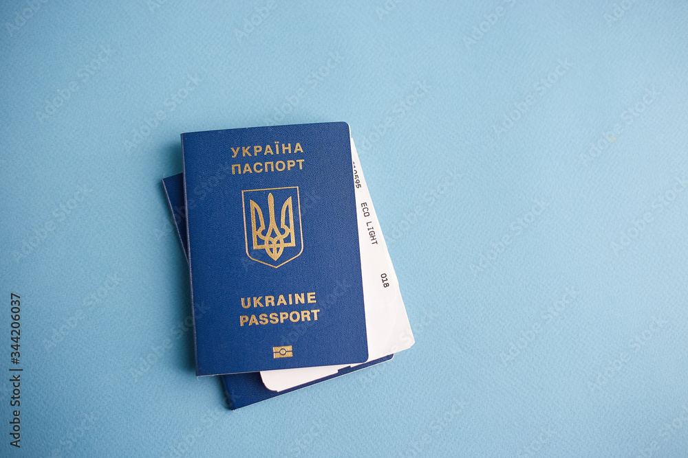 Two Ukrainian passports with a golden trident symbol on a blue ...