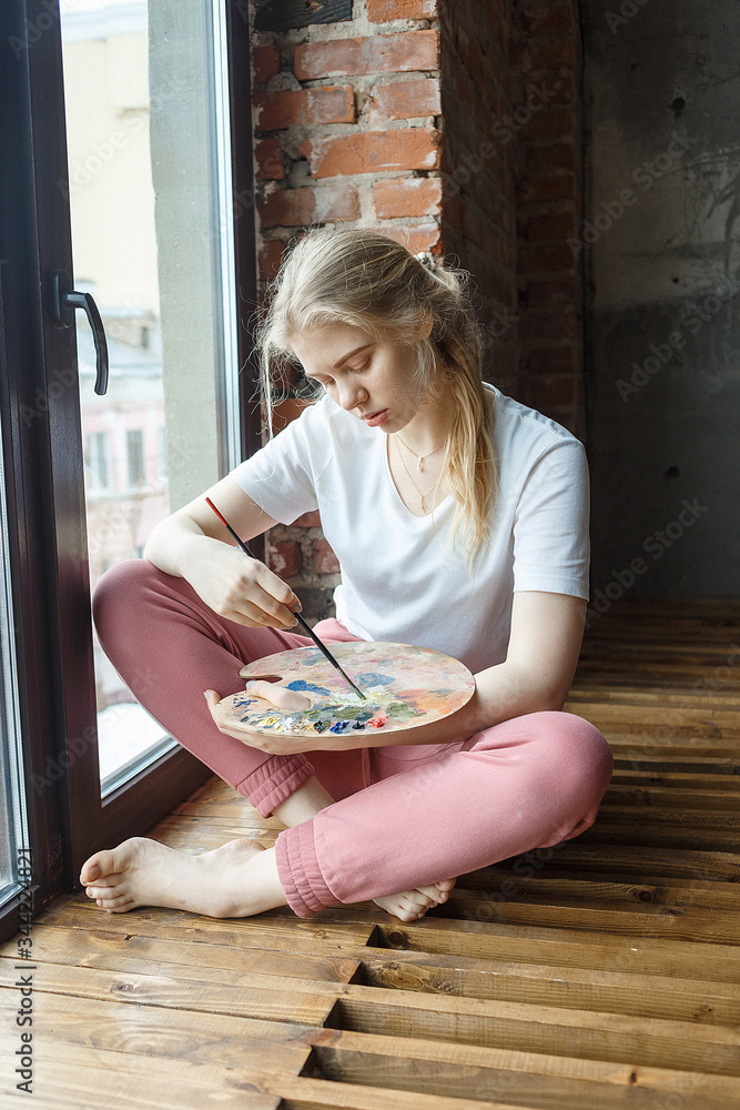 stay home, creative crisis concept: sad male artist on window sill with ...
