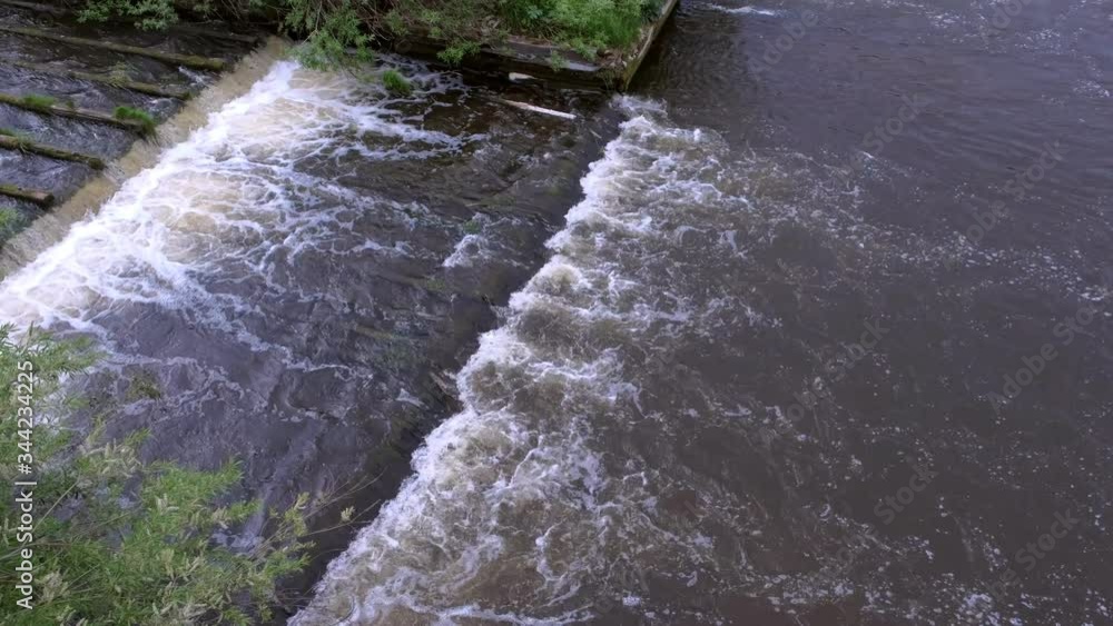 Abandoned hydroelectric power station on river, waterfalls and shallows ...