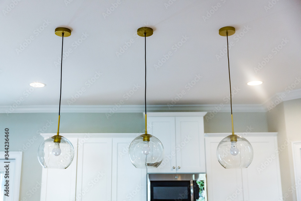 Pendant lighting in an open floor plan kitchen in a new construction ...