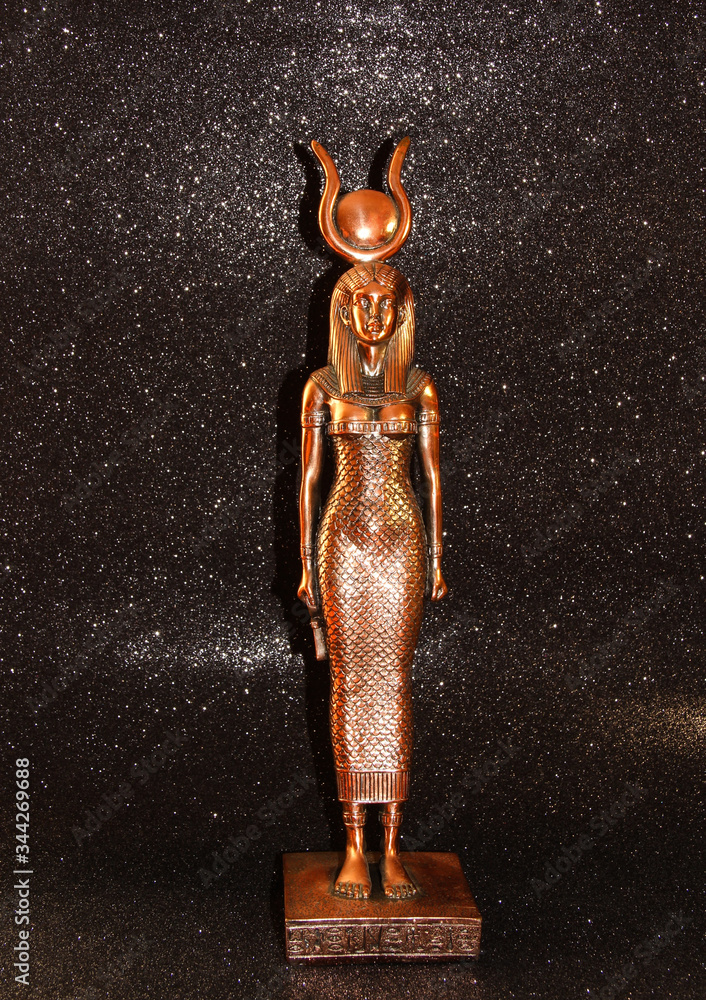 The Egyptian goddess ISIS on a black background. A bronze Egyptian ...
