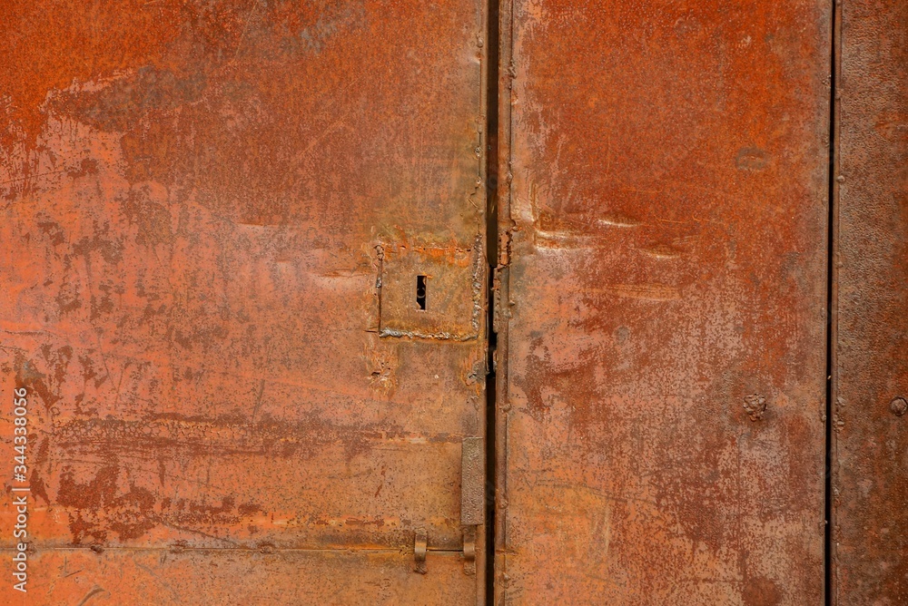 red metal texture from an old iron wall with a seam in the door on the ...