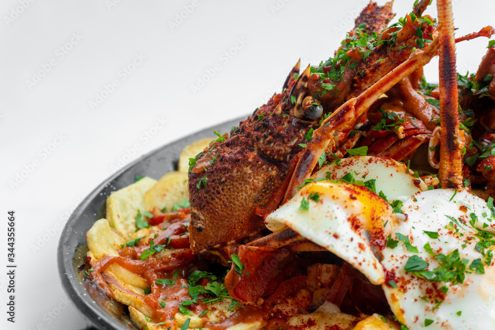 Formentera Lobster with fried potatoes, eggs and parsley in a ...