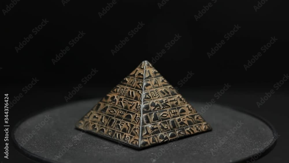 pyramid figure. pyramid figurine on a black background. the pyramid is ...