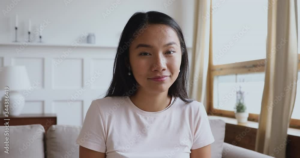 Head shot close up attractive millennial asian ethnicity woman talking ...
