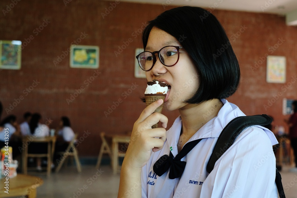 Girl Eating Ice Cream At School Stock Photo | Adobe Stock