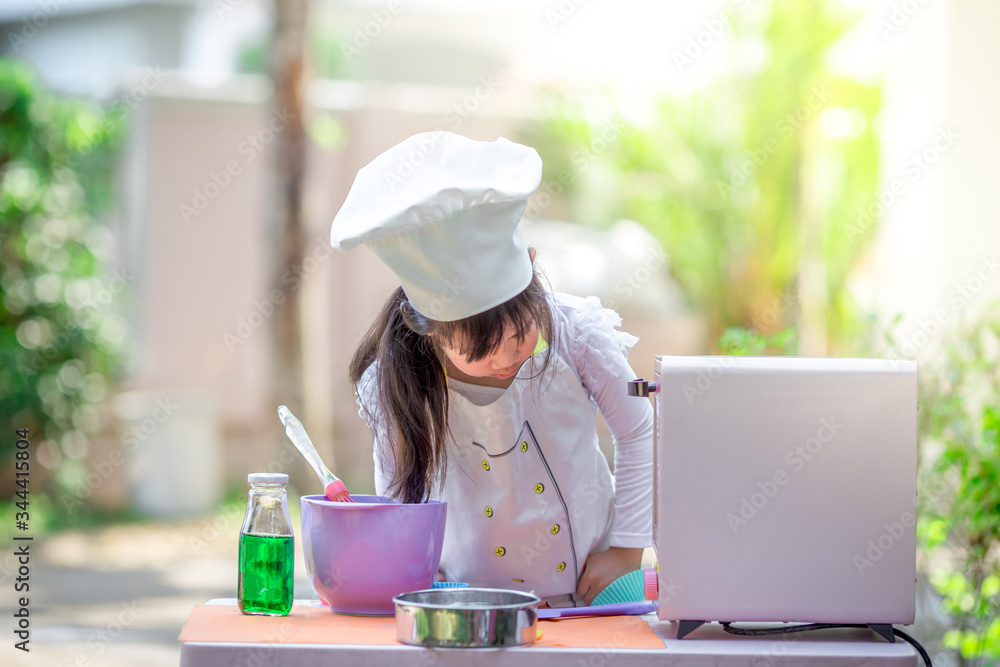 Close up background view Of cute young girls cooking desserts, with an ...