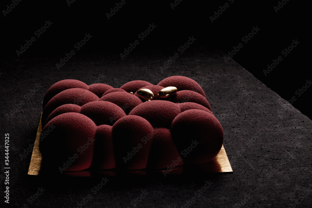 Embossed red mousse cake in the shape of bubbles and spheres with a ...