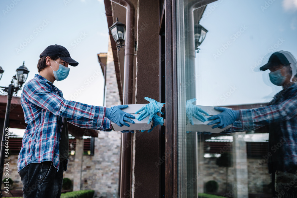 Courier and protective mask delivers parcels, customer and medical ...