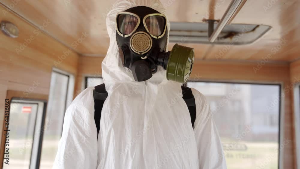 Hazmat team worker disinfects bus interior with antibacterial sanitizer ...