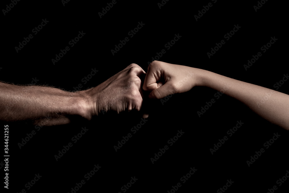 two hands fist bump together over black background Stock Photo | Adobe ...