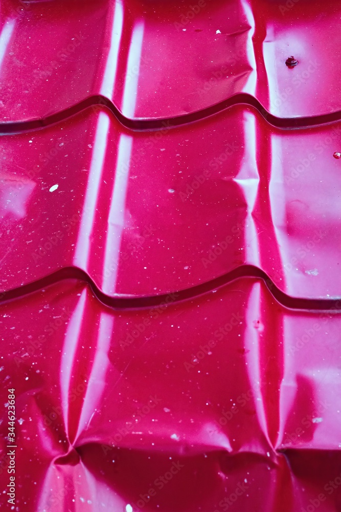 Red dented textured roof, pattern. The broken roof is produced of sheet ...