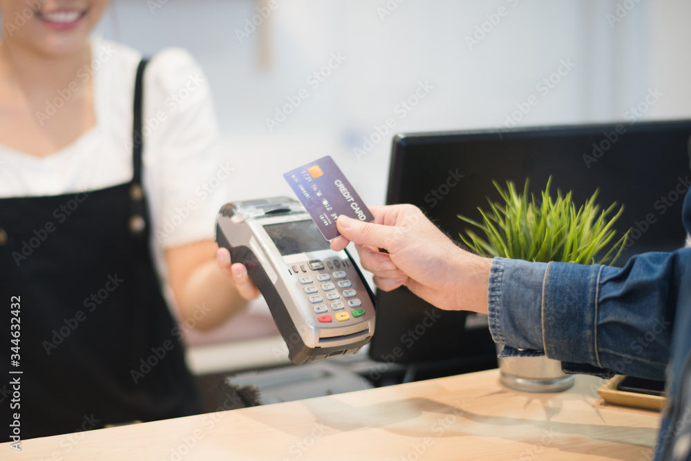 Hand of man customer using wireless or contactless payment of a credit ...