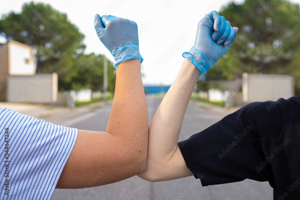 Elbow bump. New novel greeting to avoid the spread of coronavirus. Two ...