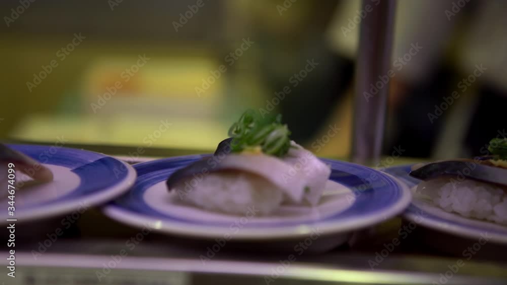 4K, Sushi on moving conveyor belt in a Japan restaurant. Traditional ...