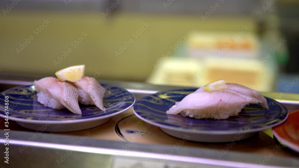 4K, Sushi on moving conveyor belt in a Japan restaurant. Traditional ...