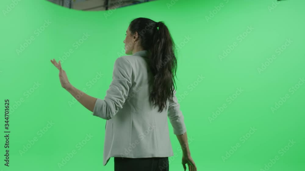 Green Screen Chroma Key Studio: Beautiful Mature Woman Looks Around in ...