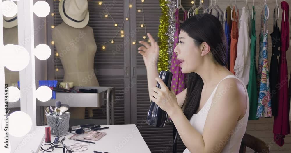 slow motion asian chinese girl singer with hair dryer singing dancing ...
