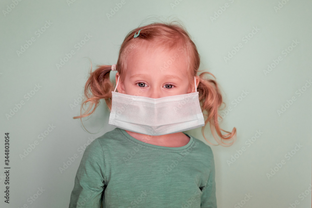 3 years old girl in face mask. Caucasian child wears facemask for ...
