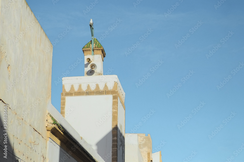 Muslim white minaret tower for calling prayer to pray at local mosque ...
