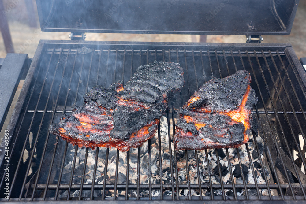 overcooked ruined black bbq ribs on the charcoal grill Stock Photo ...