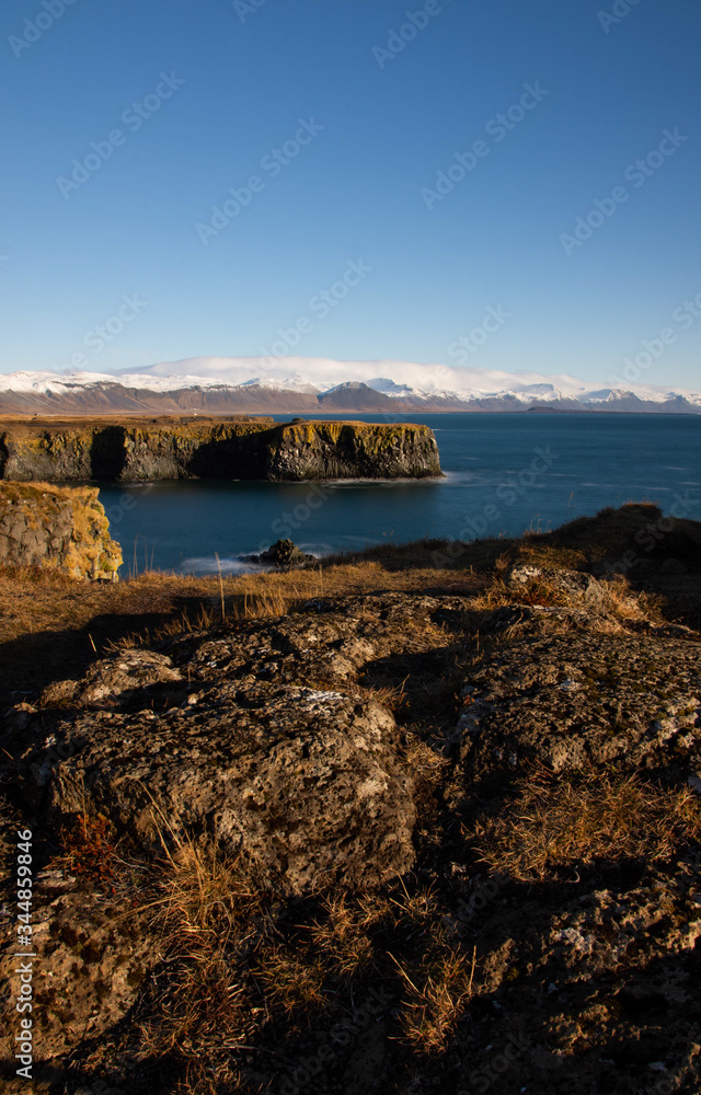Basalt Rock cliffs fall away into the calm sea below. Taken from ...