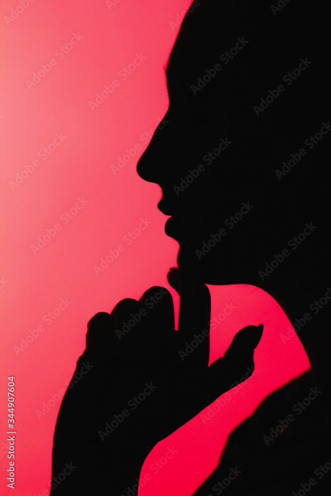silhouette of thoughtful girl with arm under chin, unrecognizable woman ...