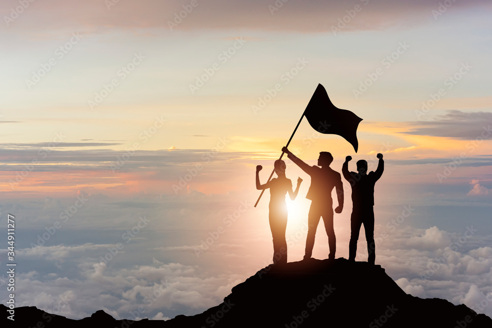 Silhouette of victory business team on mountain with sunset and sky ...