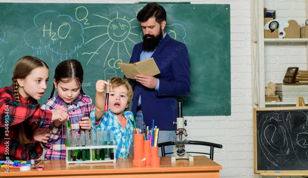 happy children & teacher. doing experiments with liquids in chemistry ...