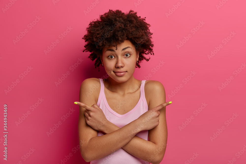 Image of confused unaware questioned Afro American woman doubts between ...