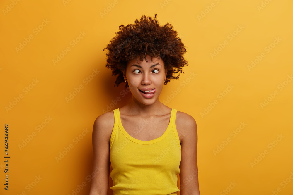 Crazy Afro American woman foolishes around, makes funny face, crosses ...