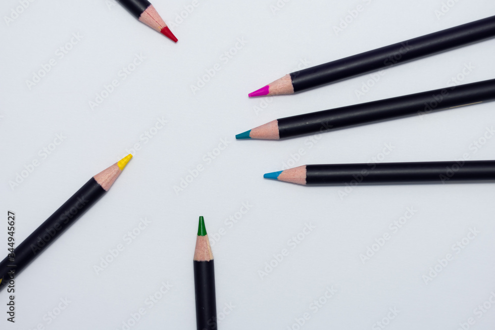 six colored pencils three of them together and the others at different ...