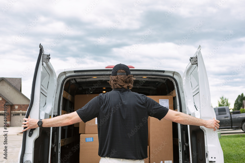 Shipment: Man Opens Rear Doors Of Delivery Van Stock Photo | Adobe Stock