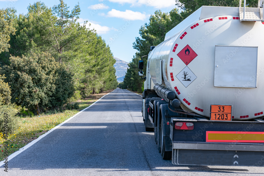 Hazard labels for flammable and polluting liquid on a fuel tank truck ...