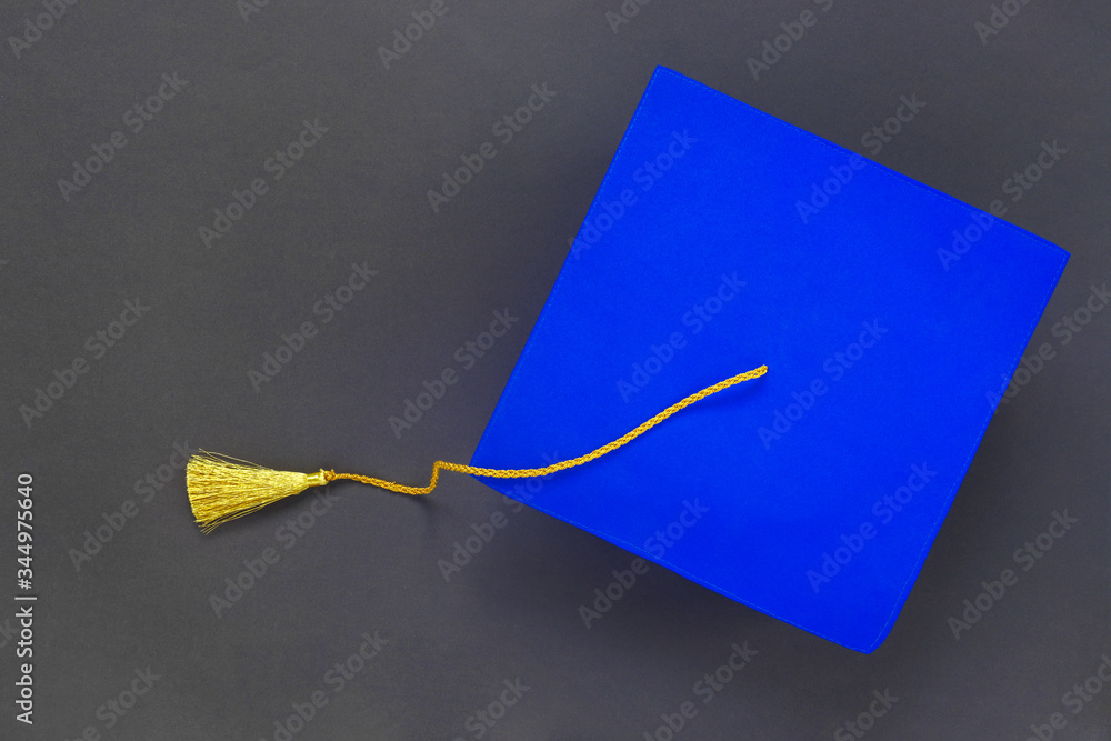 Graduation cap and diploma on black paper background. Distance ...