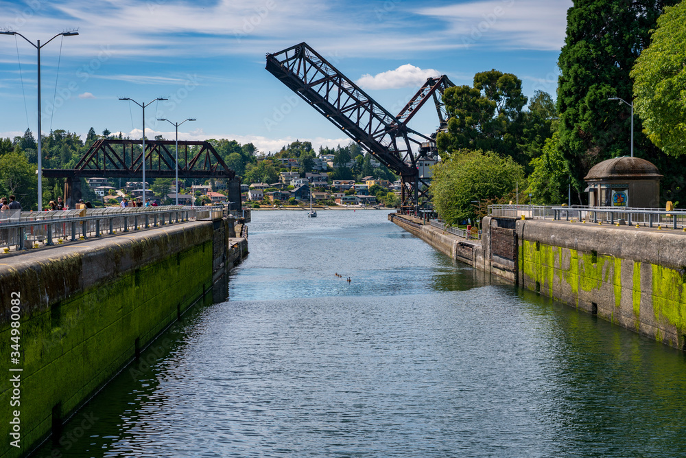 Foto de A train trestle draw bridge opens to let a tall ship pass under ...