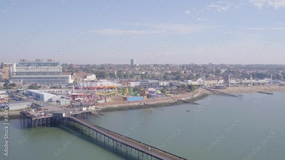 Drone or aerial pull back reveal of Southend pier and beach showing the ...