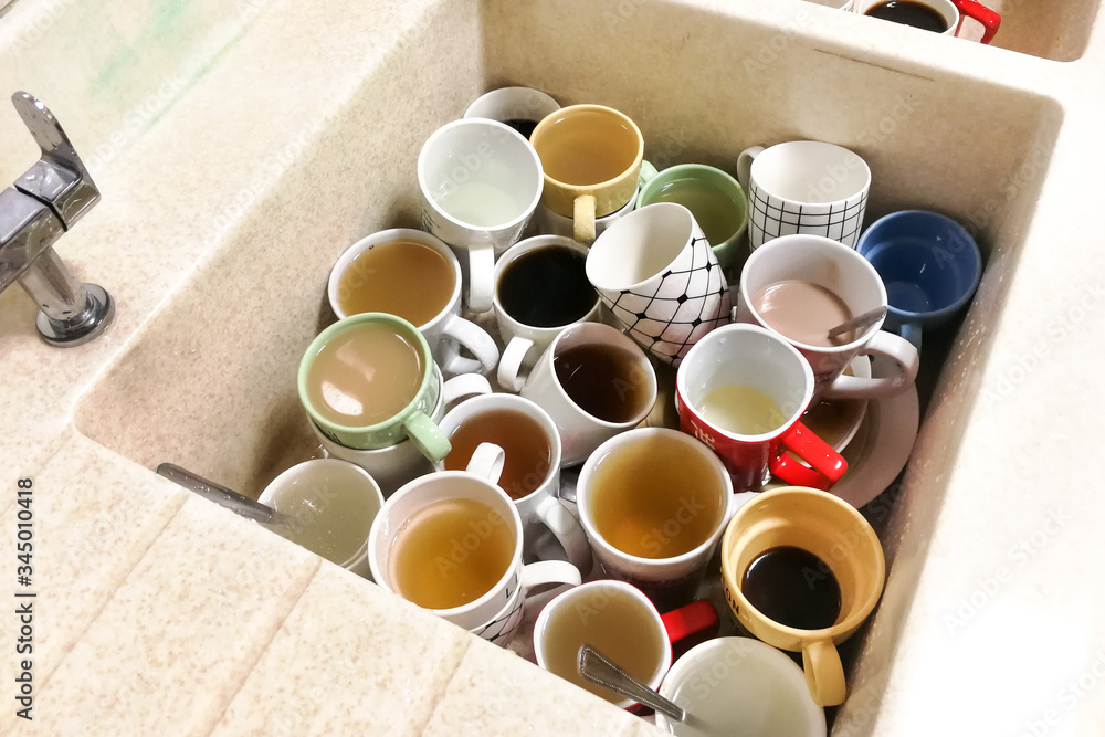 Dirty pile of unwashed cups and mugs in wash basin Stock Photo | Adobe ...