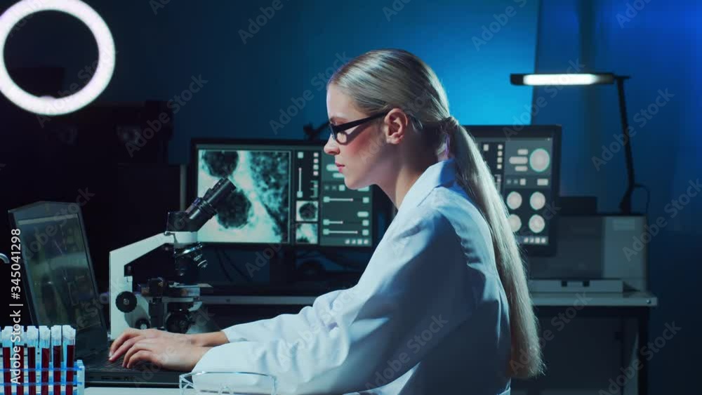 Female scientist working in modern lab. Doctor making microbiology ...