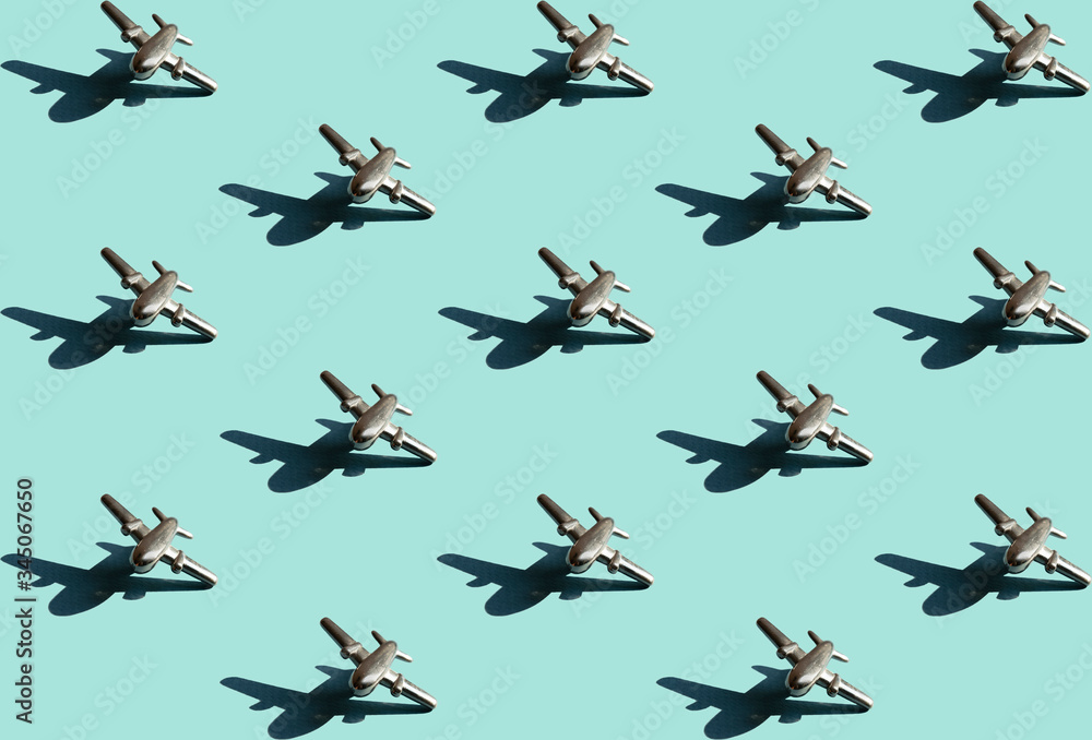 Fifteen metal figures of small airplanes with shadows with the same ...