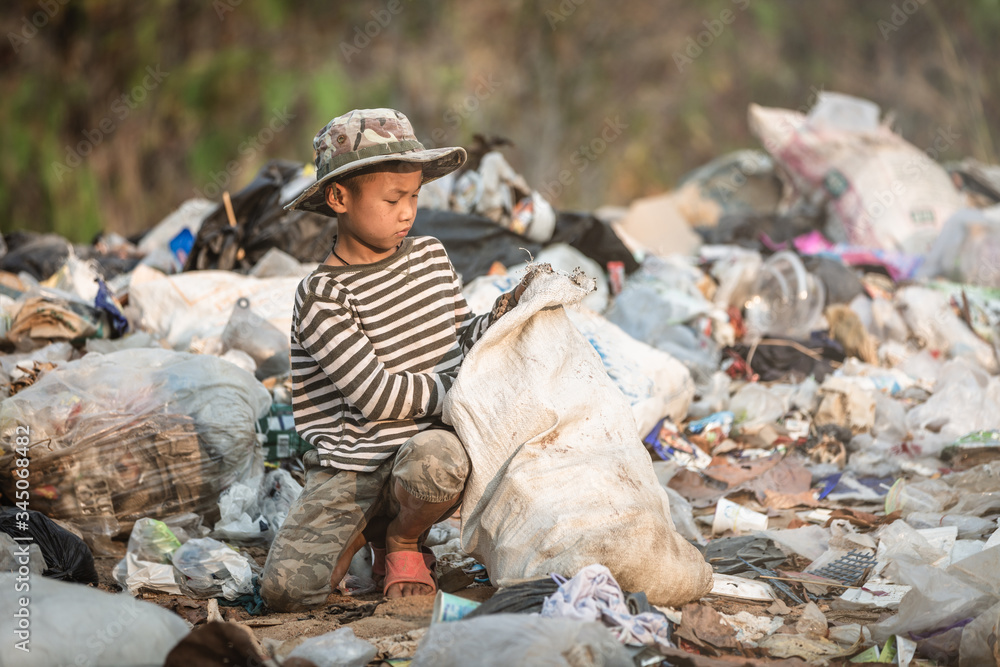 Poor boy collecting garbage in his sack to earn his livelihood, The ...