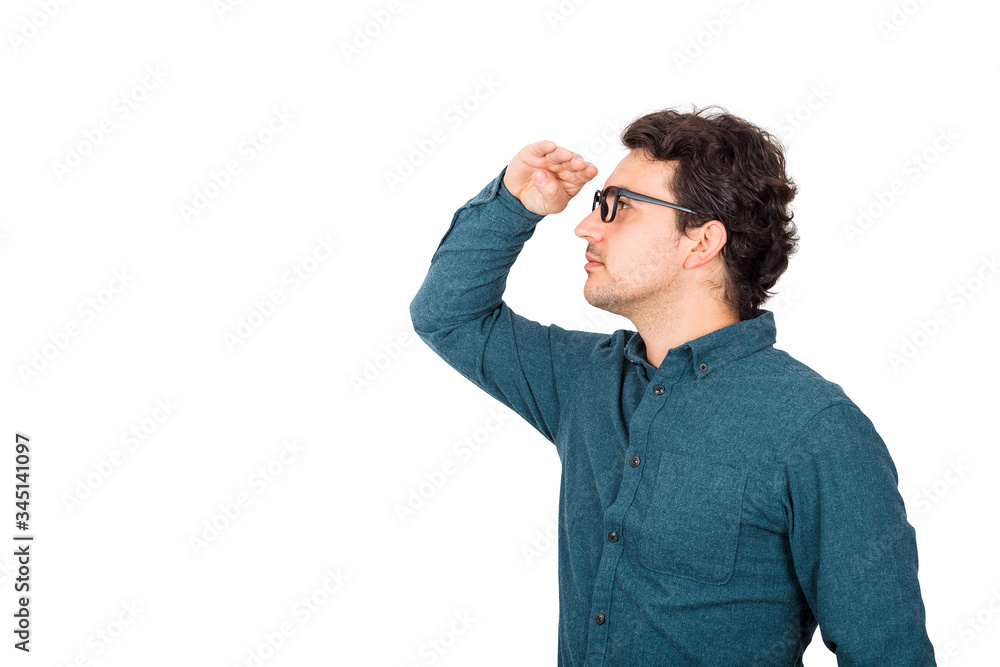 Confident businessman looking attentive far away ahead, holding hand to ...