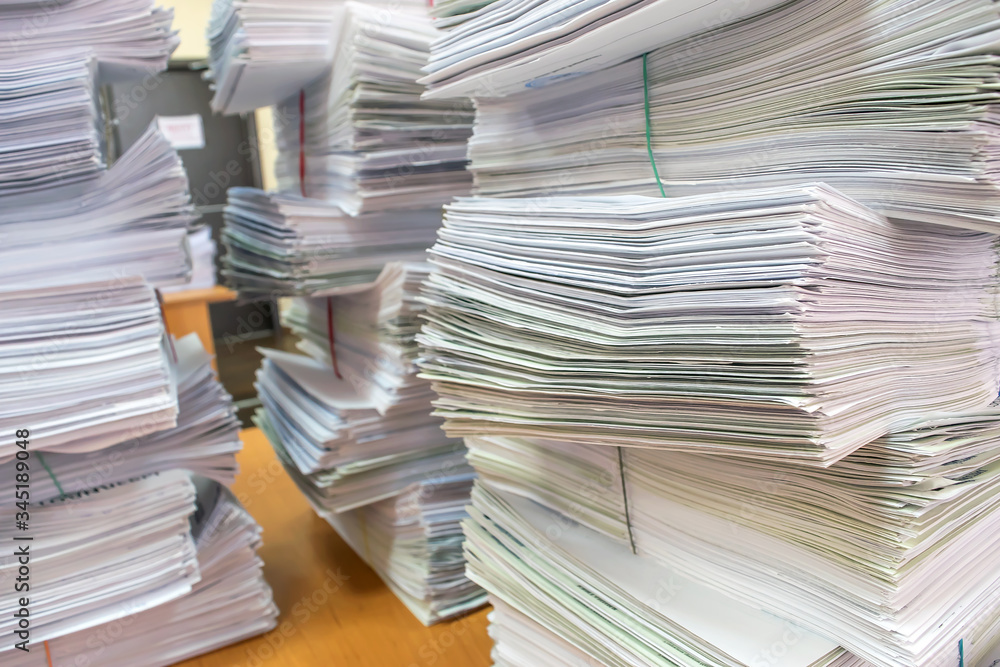 bundles bales of paper documents. stacks packs pile on the desk in the ...